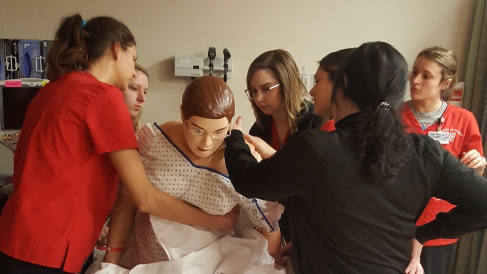 Nursing students work together to solve puzzles, treat patients, and ...